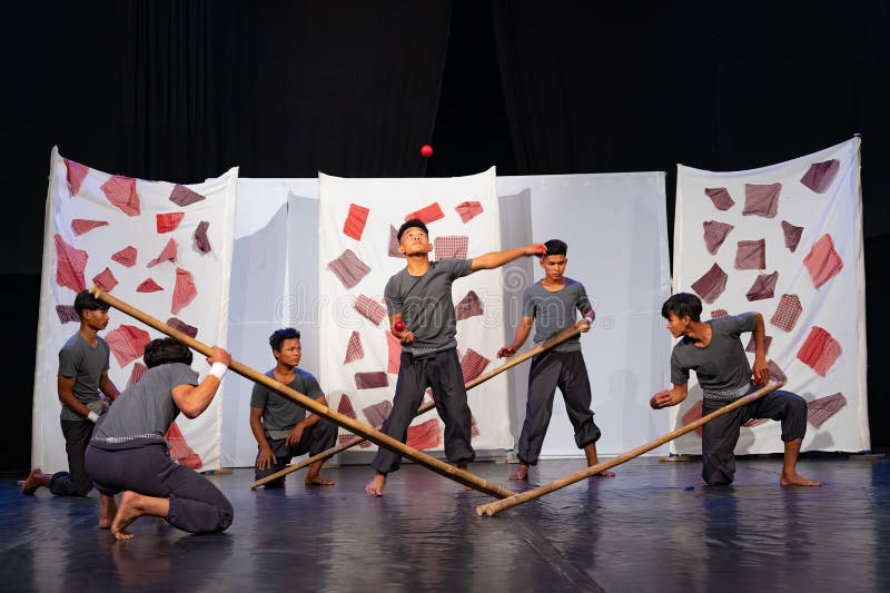 Group of People Standing on an Illuminated Stage during a Performance ...