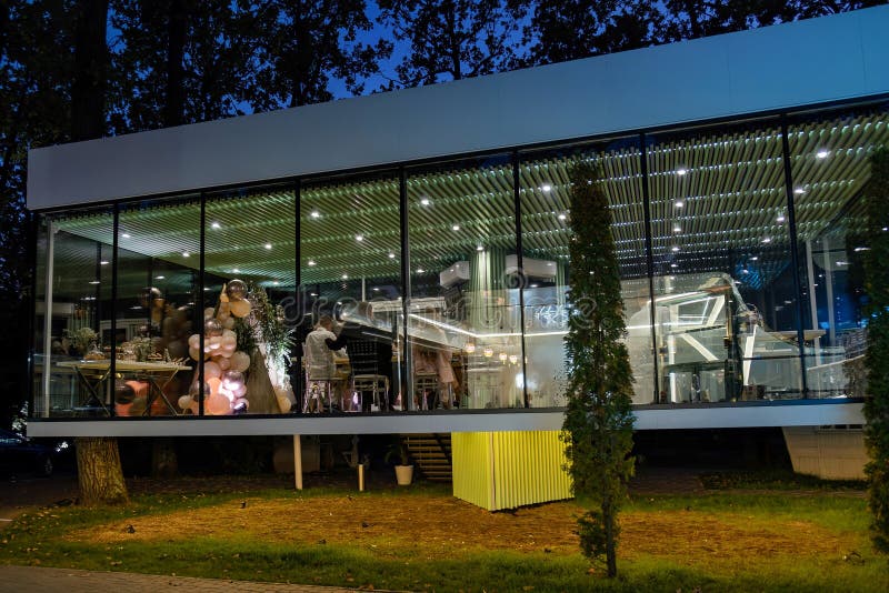 Group of People Standing Outside of Building at Night with Their ...