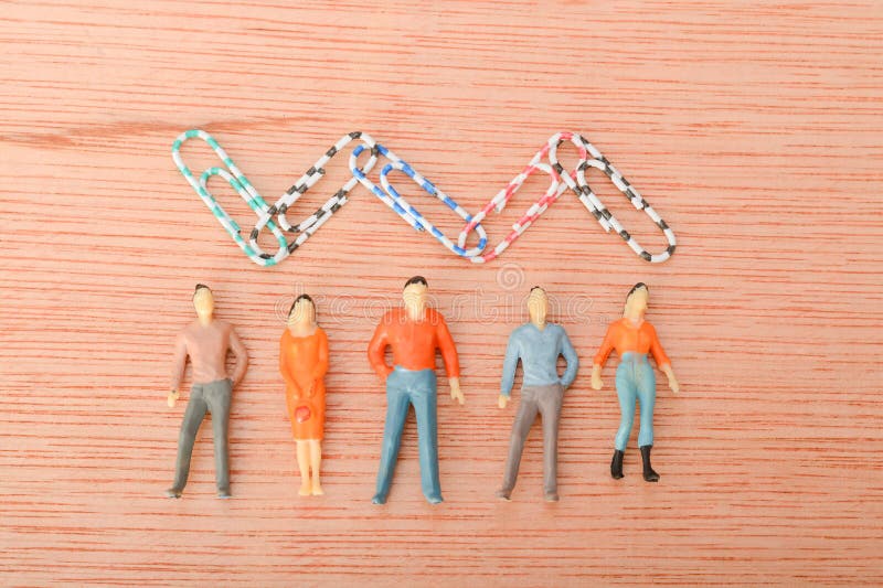 A Group of People Standing Together, with Paper Clips Serving As a ...