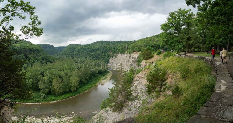 Group of People Taking a Leisurely Stroll Down a Winding Pathway Along ...