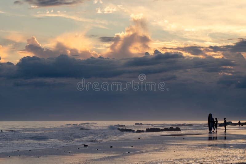 A Group of People are Walking on the Beach at Sunset Stock Image ...
