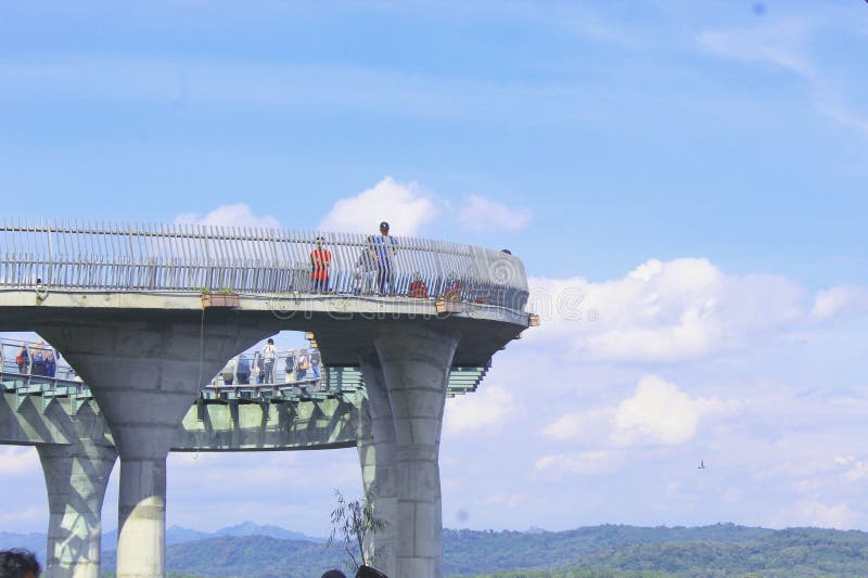Modern Pedestrian Skywalk with Tourists and Scenic Mountain View Stock ...