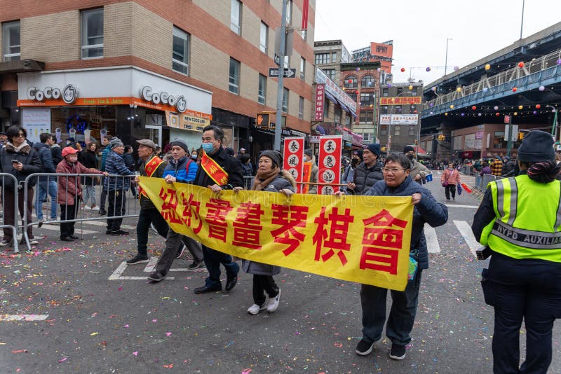 Group of People Walking with a Large Yellow Sign during a Chinese ...
