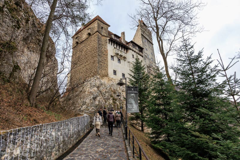 Group of People are Walking Up a Stone Path in Front of a Castle ...