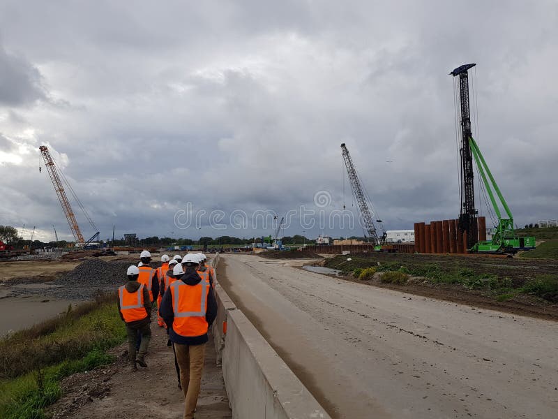 Group of People Wearing Reflective Clothes and Helmets while Visiting ...