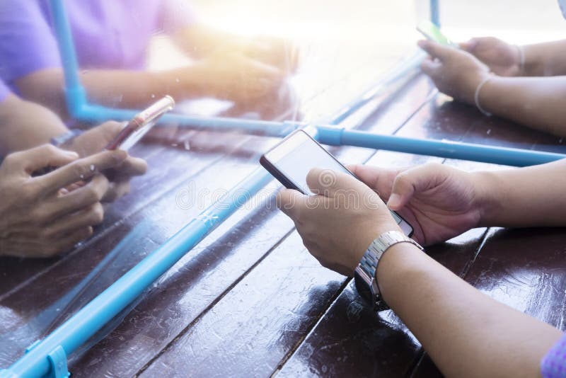 A Group of People Who are Using a Smartphone with a Partition between ...
