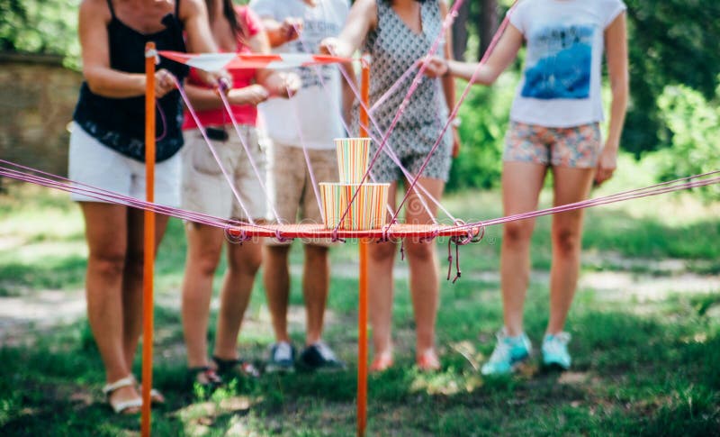 A Group of People at Work Perform a Team-building Exercise, Carrying ...