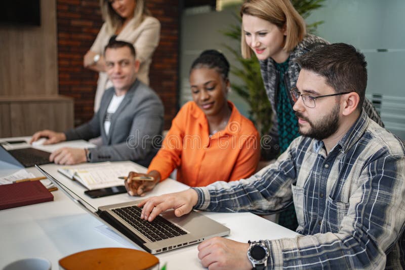 Group of People Working on Laptops at Table Stock Image - Image of busy ...