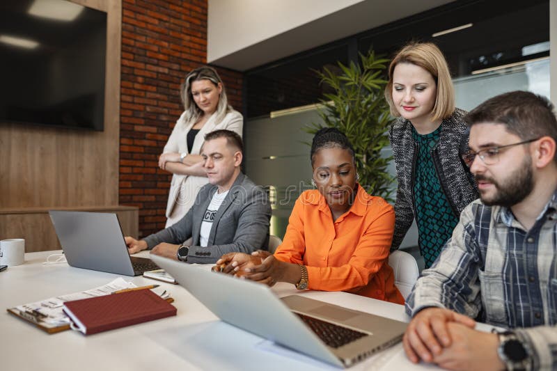 Group of People Working at Table with Laptops Stock Image - Image of ...
