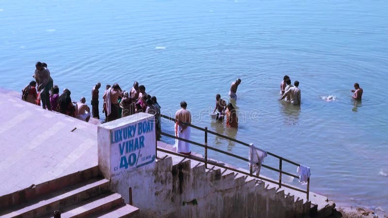 Group of Men Bathing and Sitting at Ghat of Ganges River in Varanasi ...