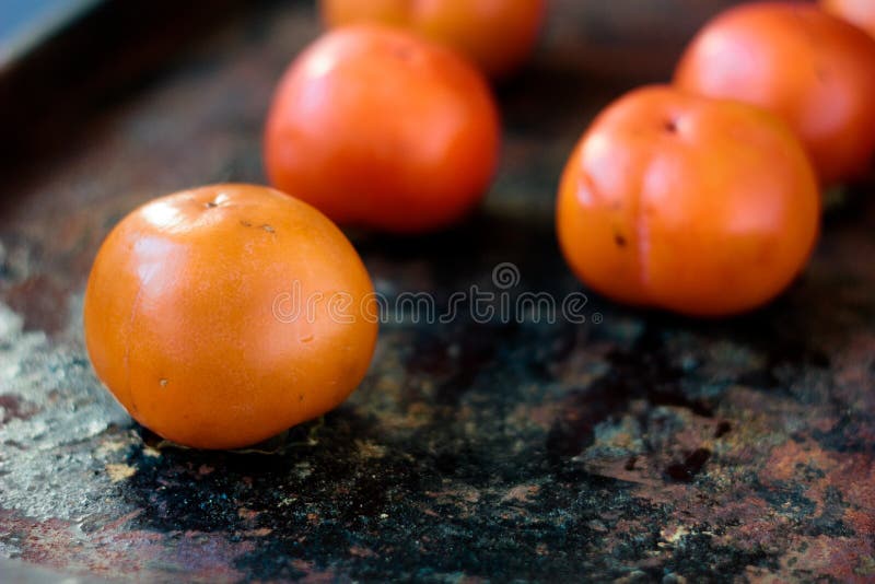 Group of Persimmons on Black Rustic Surface. Stock Photo - Image of ...