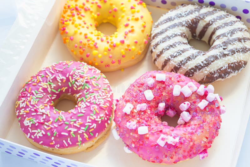 A Group of Pink, Yellow and Chocolate Donuts with Sprinkles in Cartoon ...