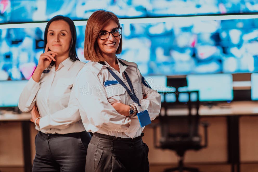 Group Portrait of Female Security Operator while Working in a Data System Control Room Offices ...