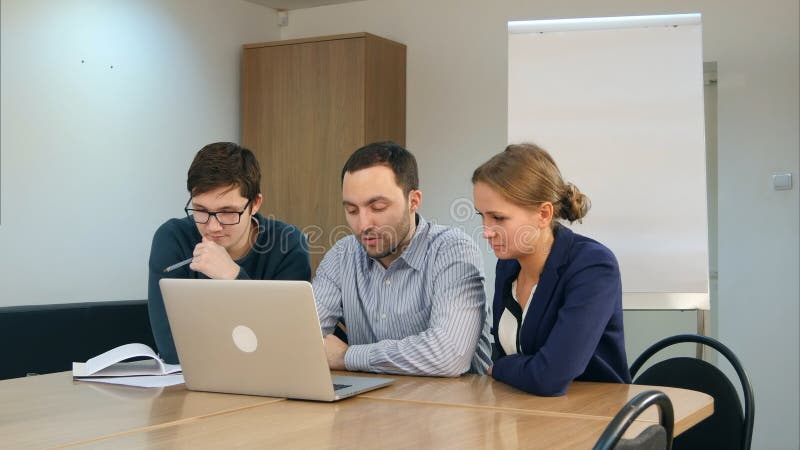 Group of Positive Cheerful Students Using Laptop and Doing Homework ...