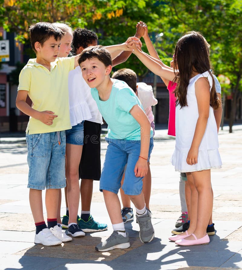Group of Positive Children Holding Hands Up and Playing Together Stock ... Group of Positive Children Holding Hands Up and Playing Together Stock ...