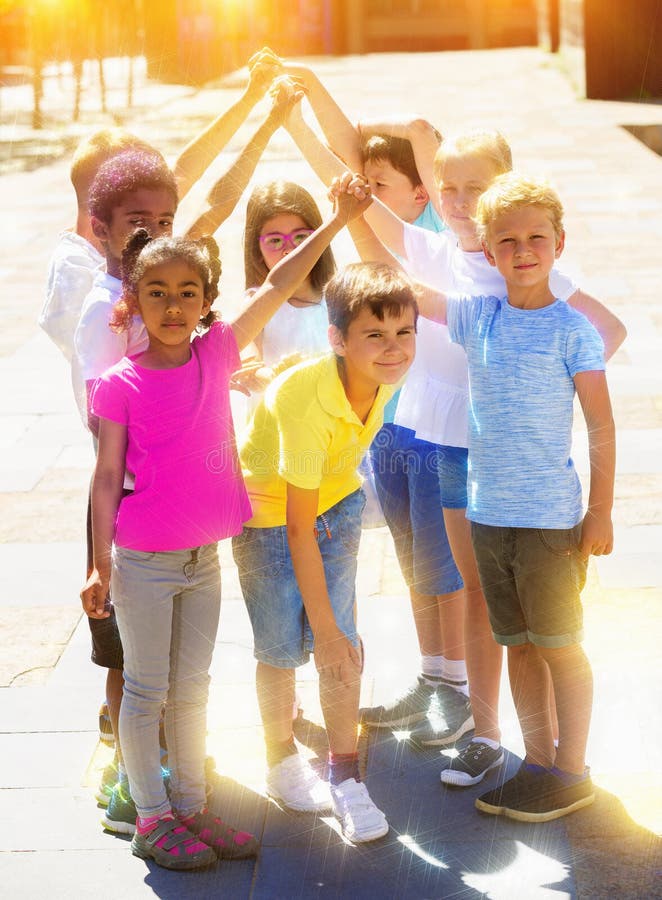 Group of Positive Children Holding Hands Up and Playing Together Stock ... Group of Positive Children Holding Hands Up and Playing Together Stock ...