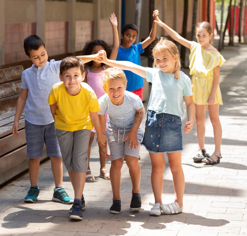 Group of Positive Schoolchildren Holding Hands Up and Playing Stock ... Group of Positive Schoolchildren Holding Hands Up and Playing Stock ...