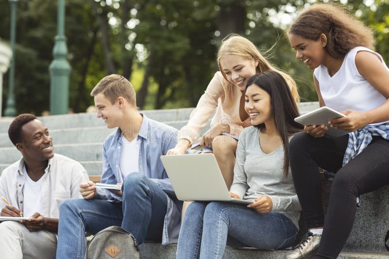 Students Doing Group Project on Laptop, Sitting in University Campus ...