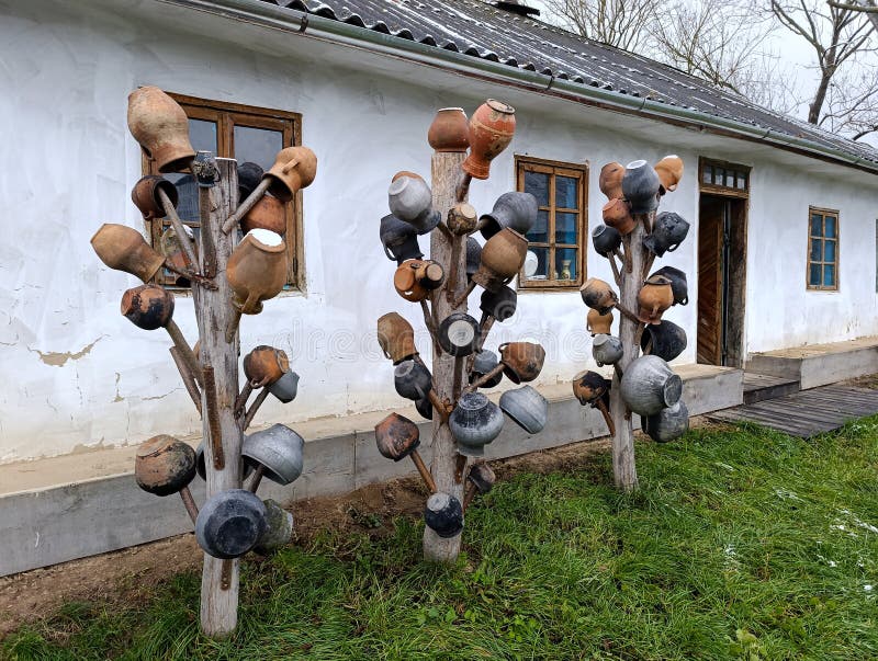 A Group of Pots and Pans on a Tree in Front of a House Stock Photo ...