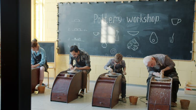 Group of Pottery Masterclass Students Making Pots Using Throwing Wheels ...
