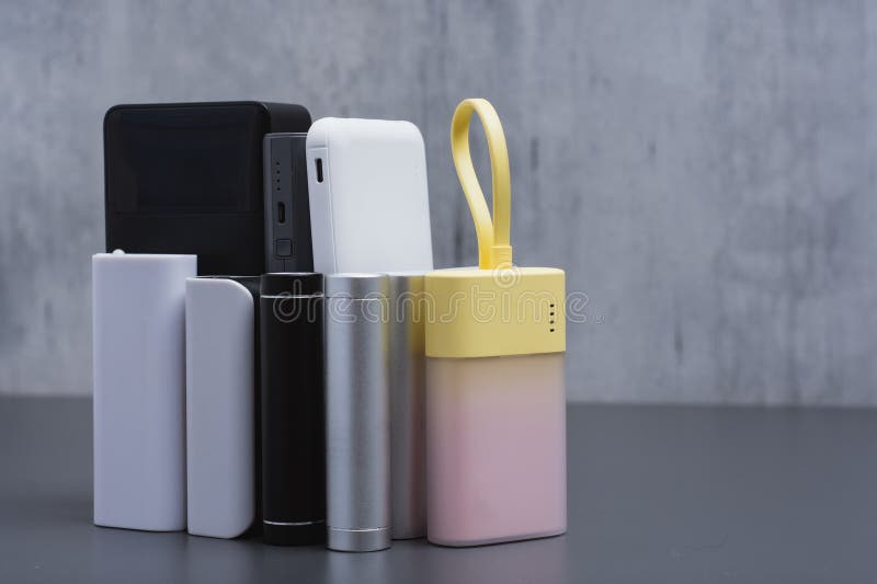 A Group of Power Banks in Various Shapes, Sizes, and Colors on a Table ...