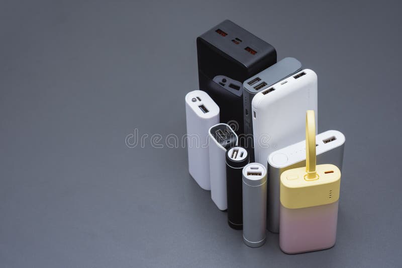 A Group of Power Banks in Various Shapes, Sizes, and Colors on a Table ...