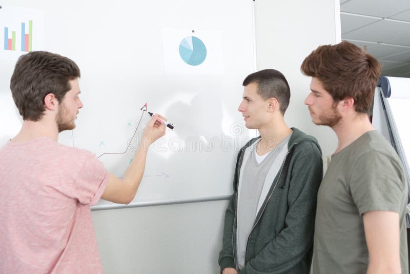 Group Presenting and Writing on Whiteboard Stock Photo - Image of ...