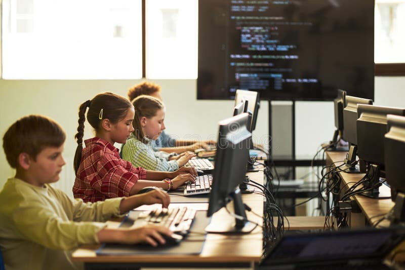 Group of Preteen Children Coding on Computers during Programming Class ...