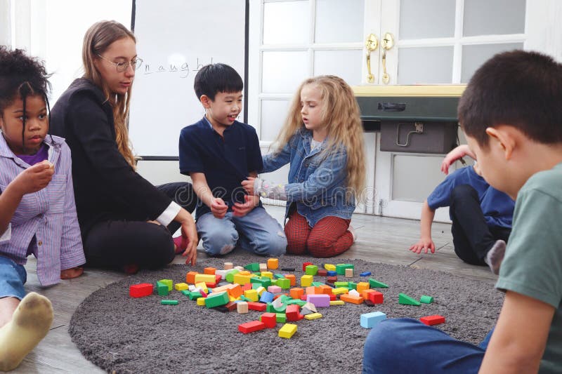 Group of Primary School Children Study and Play Together in Classroom ...