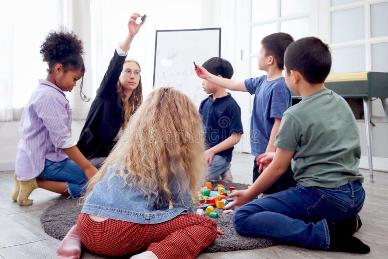 Group of Primary School Children Study and Play Together in Classroom ...