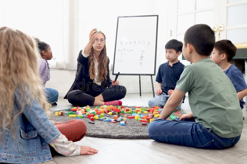 Group of Primary School Children Study and Play Together in Classroom ...