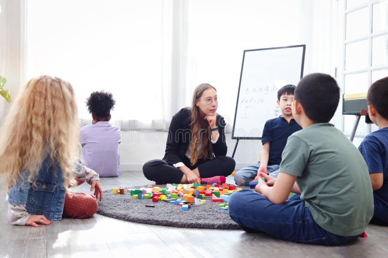 Group of Primary School Children Study and Play Together in Classroom ...