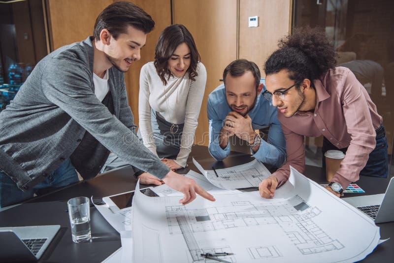 Group of Professional Architects Discussing Building Plans Stock Photo ...