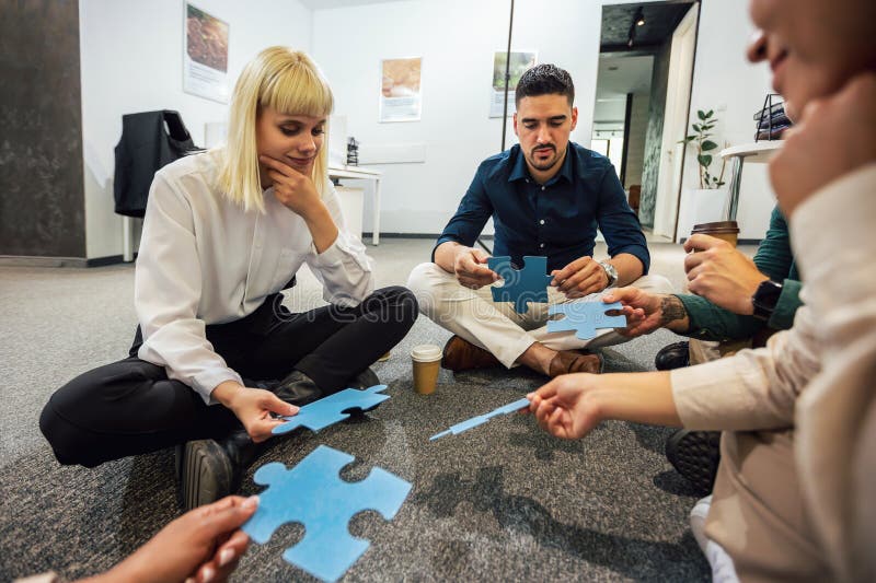 Group of Professional People Playing Puzzle in the Office Stock Photo ...