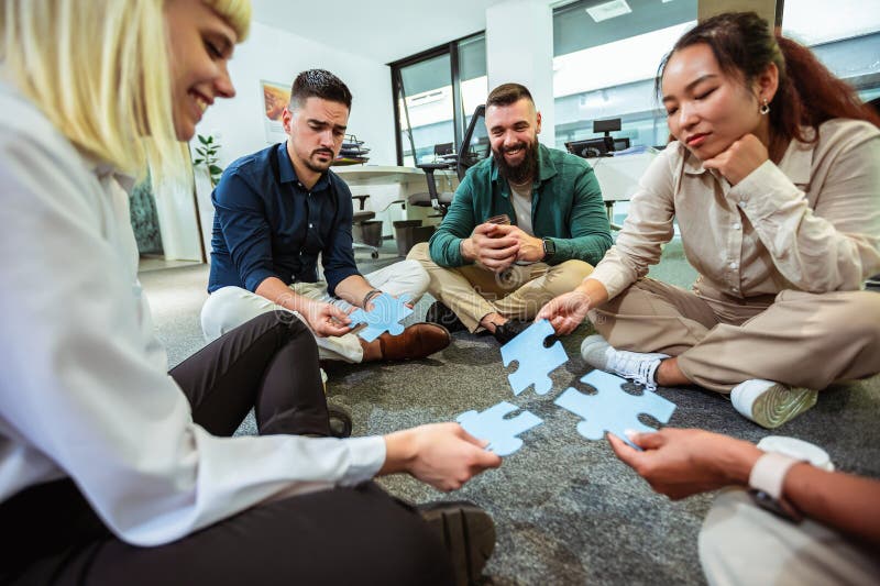 Professional People Playing Puzzle on the Floor of the Office.Team ...