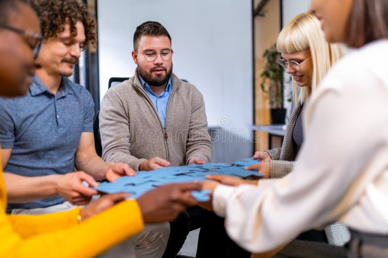 Group of Professional People Playing Puzzle in the Office. Stock Photo ...