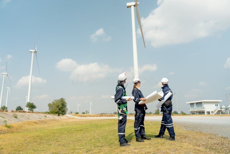Group of Professional Technician Workers Stand with Holding Project Paper Plan in Front of Wind ...
