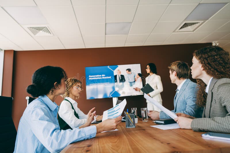 Professional Group in a Corporate Meeting Discussing Project Details in ...