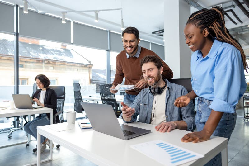 Group of Professionals Collaborating and Using Laptop in Coworking ...