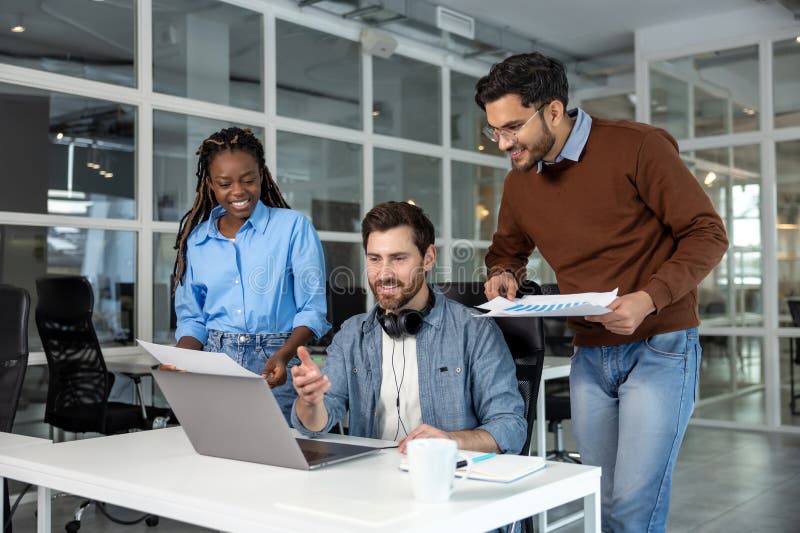 Group of Professionals Collaborating and Using Laptop in Coworking ...