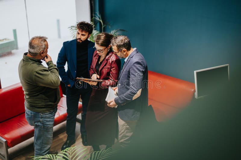 Group of Professionals Discussing Documents in a Modern Office Stock ...