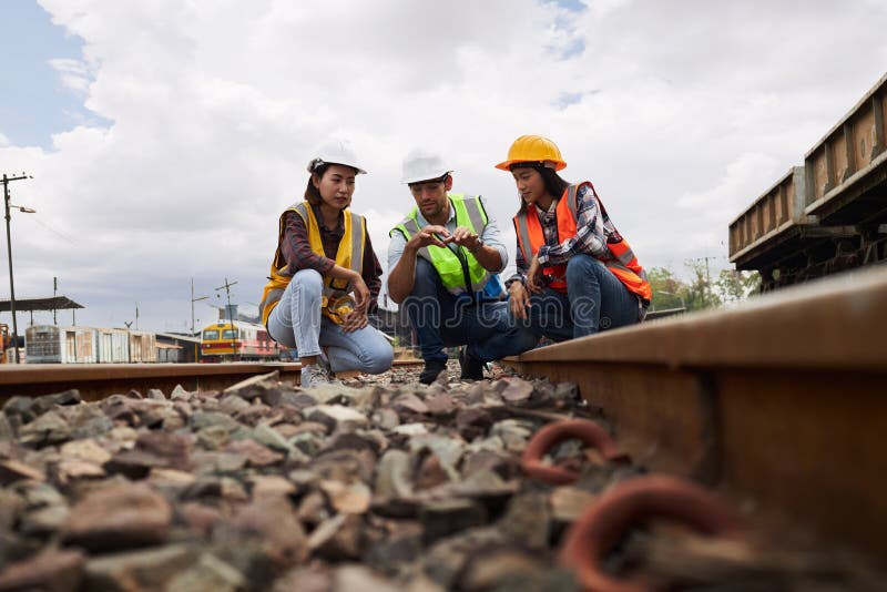 A Group of Rail Transport Specialist Engineers is Working on the Train ...
