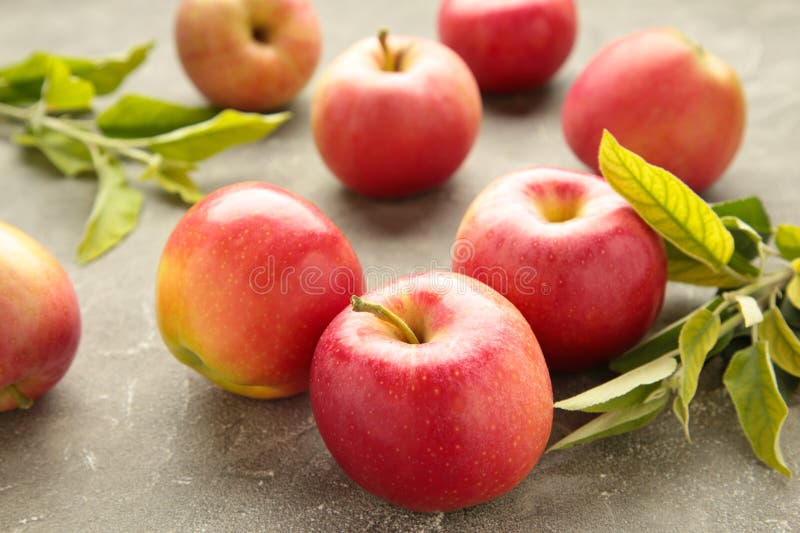 Group of Red Apples with Their Leaves on Grey Background Stock Image ...