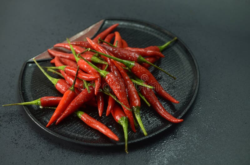 Group of Wet and Fresh Red Chilli on Black Plate Stock Image - Image of ...