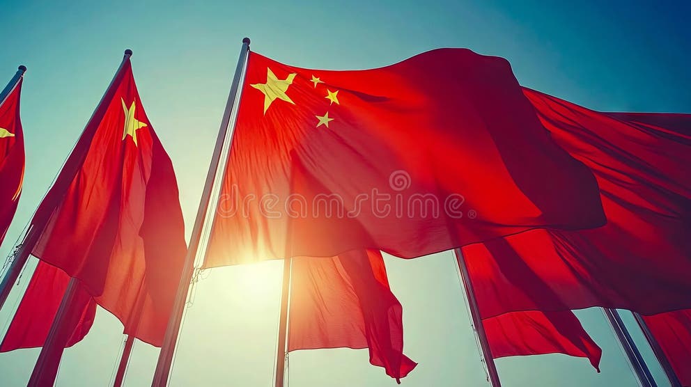 A Group of Red Flags Flying in the Wind Against a Blue Sky Stock Photo ...