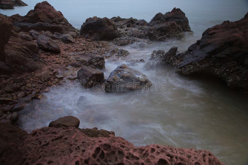 Red rocks on the coast stock photo. Image of island - 380865300