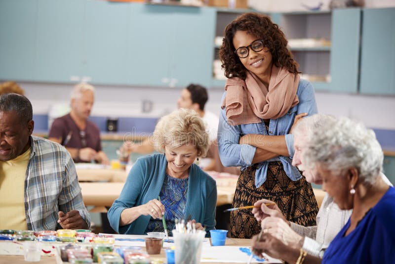 Group of Retired Seniors Attending Art Class in Community Centre with ...