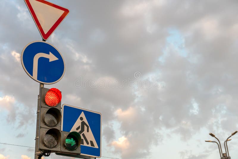 A Group of Road Signs and a Traffic Light with an Additional Section at ...