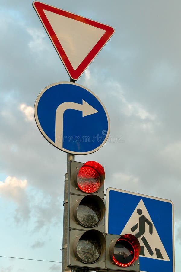 A Group of Road Signs and a Traffic Light with an Additional Section at ...