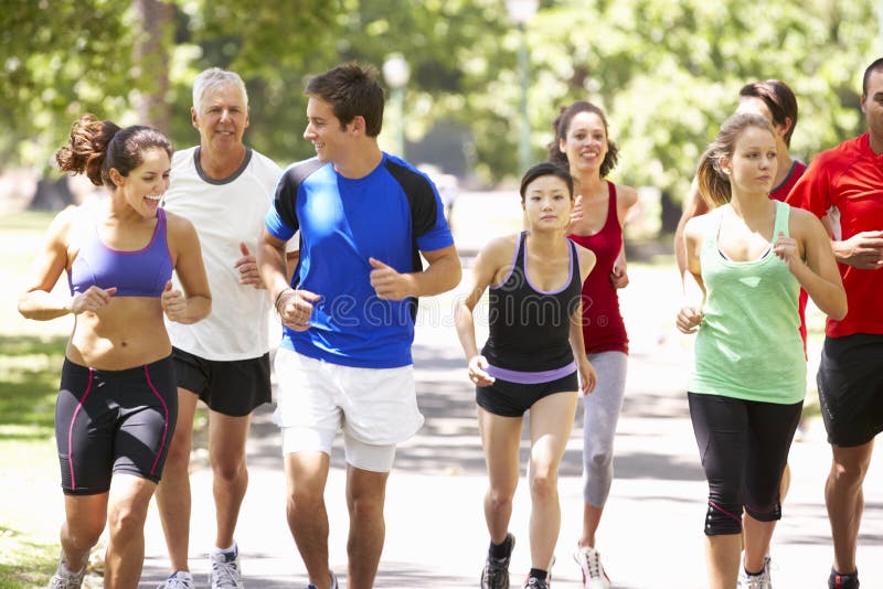 Group of Runners Jogging through Park Stock Image - Image of active ...